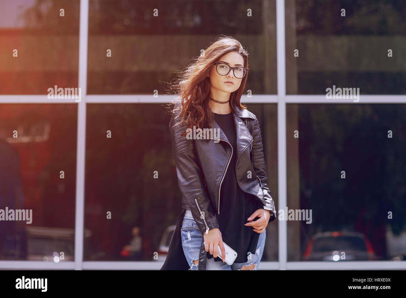 stylish young model walk in the street and pose for a photo on a Sunny ...