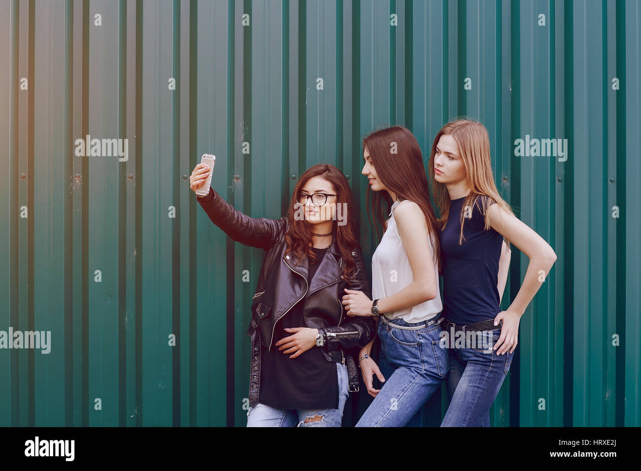 stylish young model walk in the street and pose for a photo on a Sunny ...