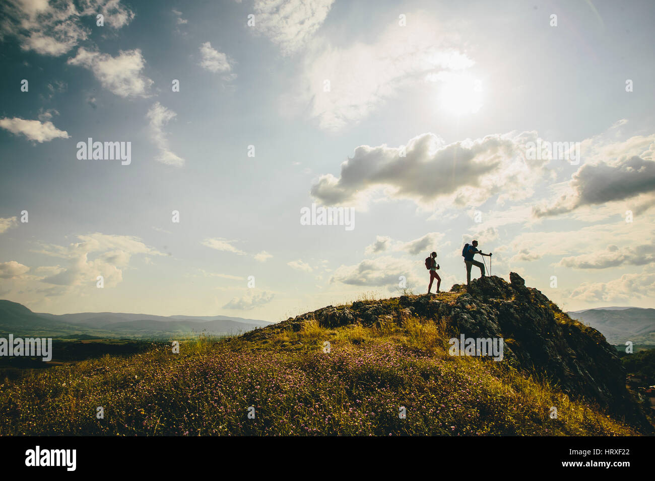 Hikers with backpacks walking on top of a mountain and enjoy hiking ...