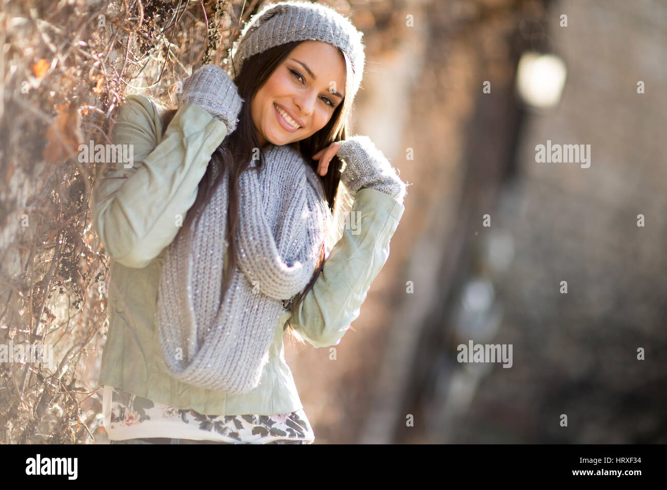 Pretty young woman with cap in the park Stock Photo - Alamy