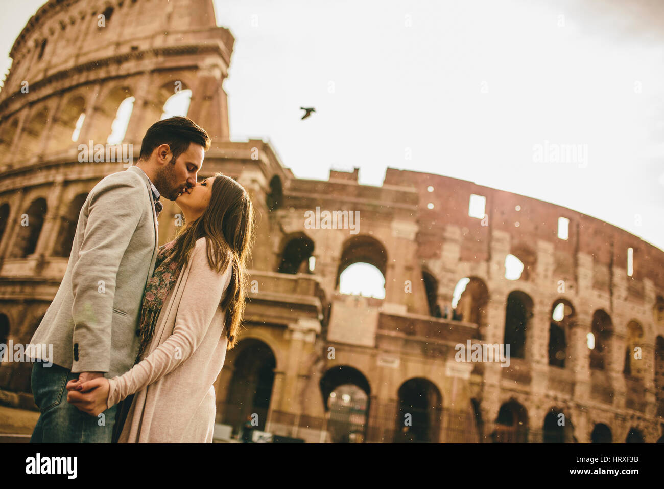 Loving couple in front of the Colosseum in Rome Stock Photo - Alamy
