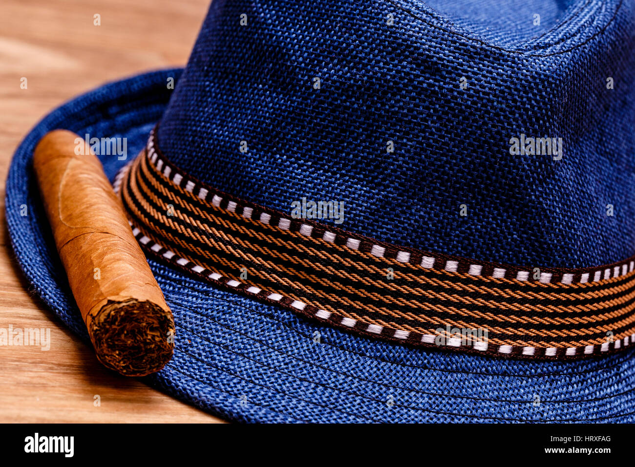 blue hat and cigar on wooden floor, smoke relax concept Stock Photo - Alamy