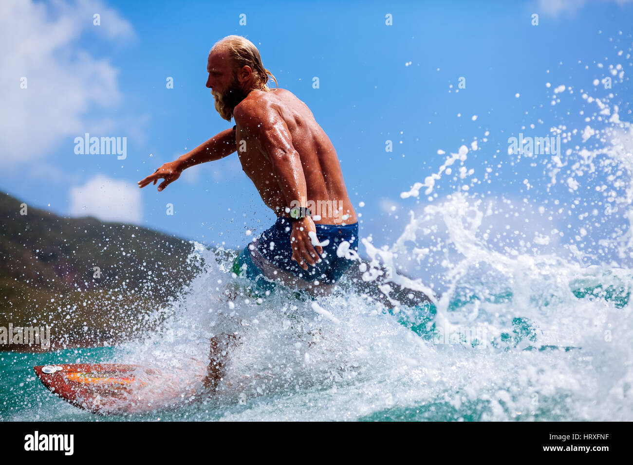 man with beard surfing wave splash actively Stock Photo - Alamy