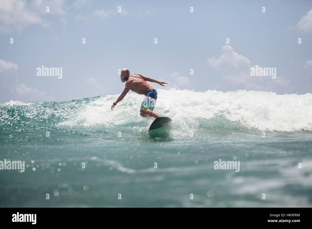 surfer man surfing on waves splash actively Stock Photo - Alamy