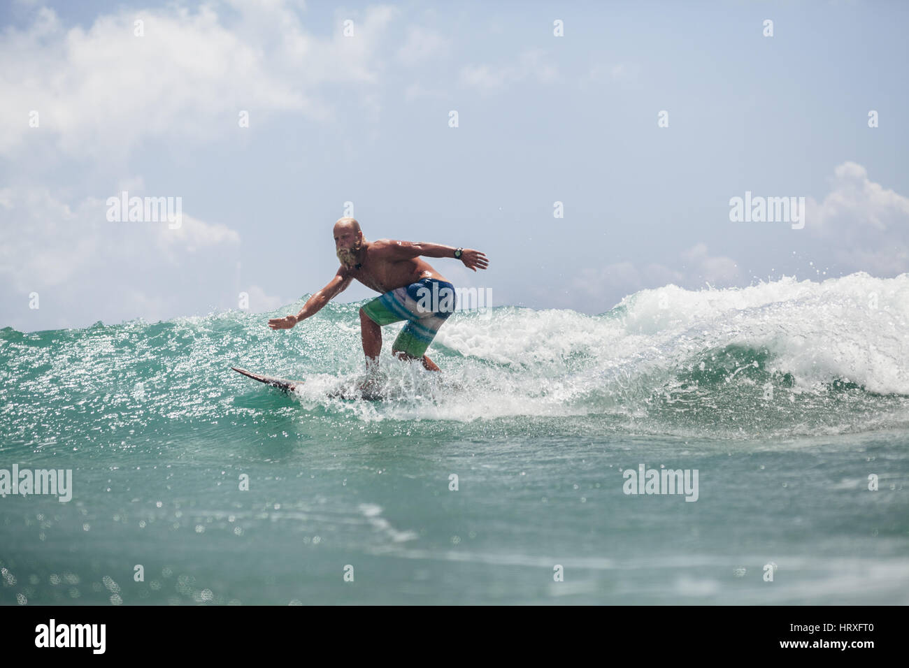 surfer man surfing on waves splash actively Stock Photo - Alamy
