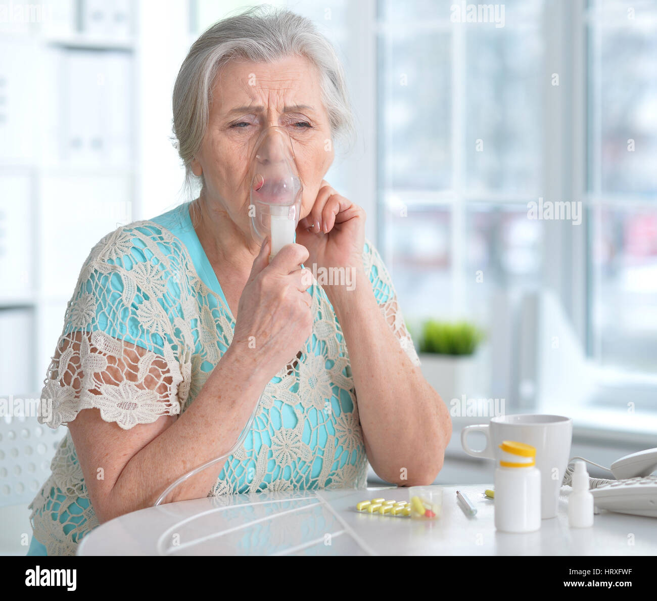 Portrait of a sick elderly woman making inhalation Stock Photo - Alamy