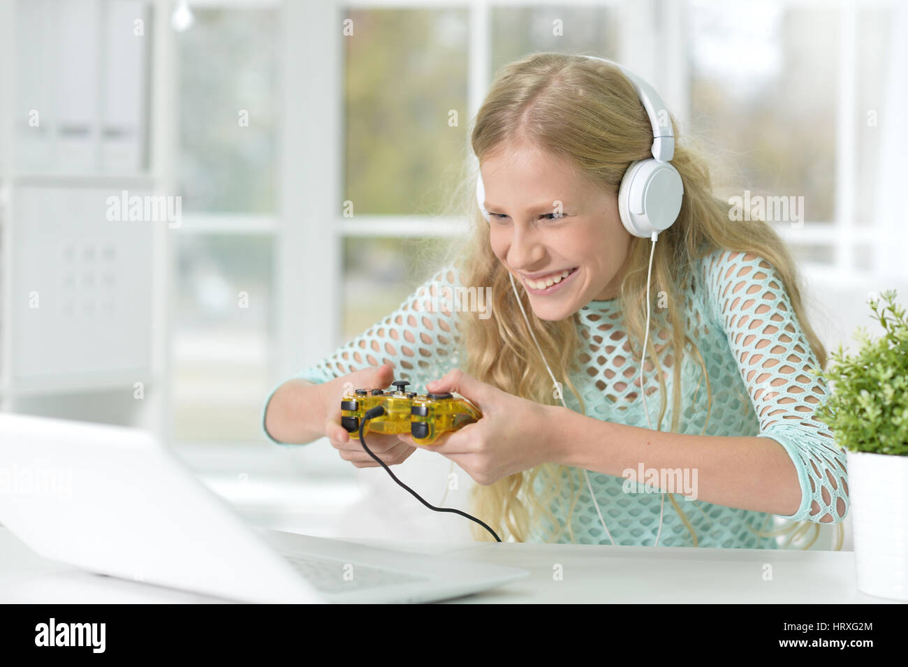 Portrait of a teenage girl playing a computer game Stock Photo - Alamy