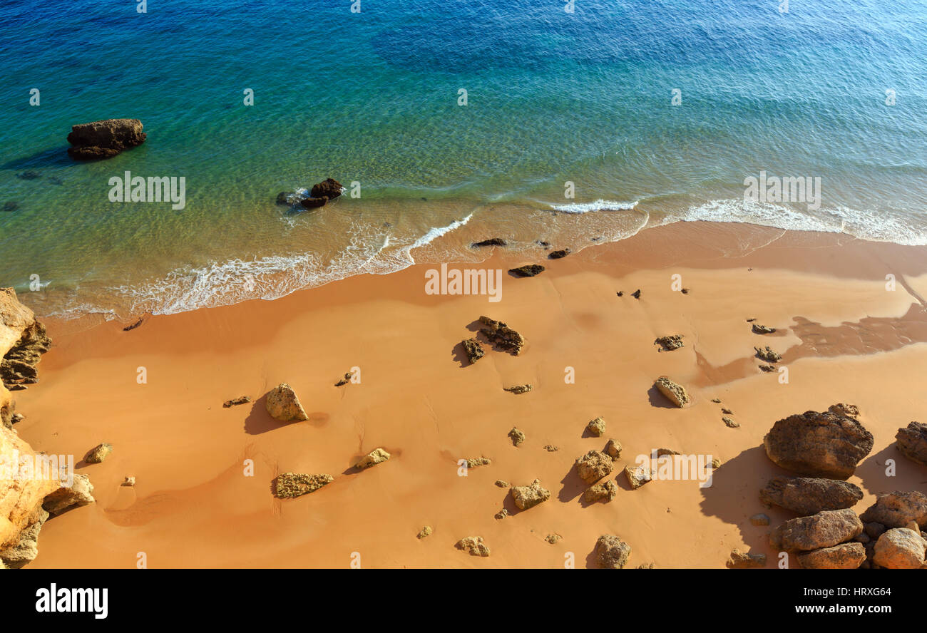 Big rock debris on sandy beach. Evening top view Stock Photo - Alamy