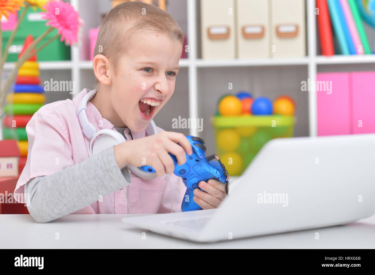 Portrait of a boy playing a computer game Stock Photo - Alamy
