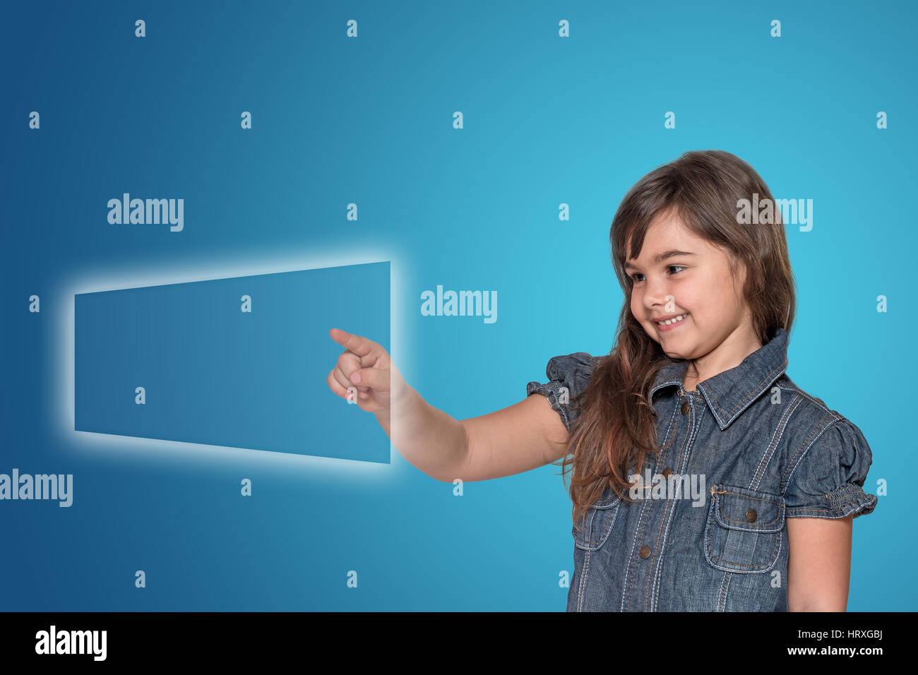 Smiling little girl is touching the transparent rectangle touchscreen ...