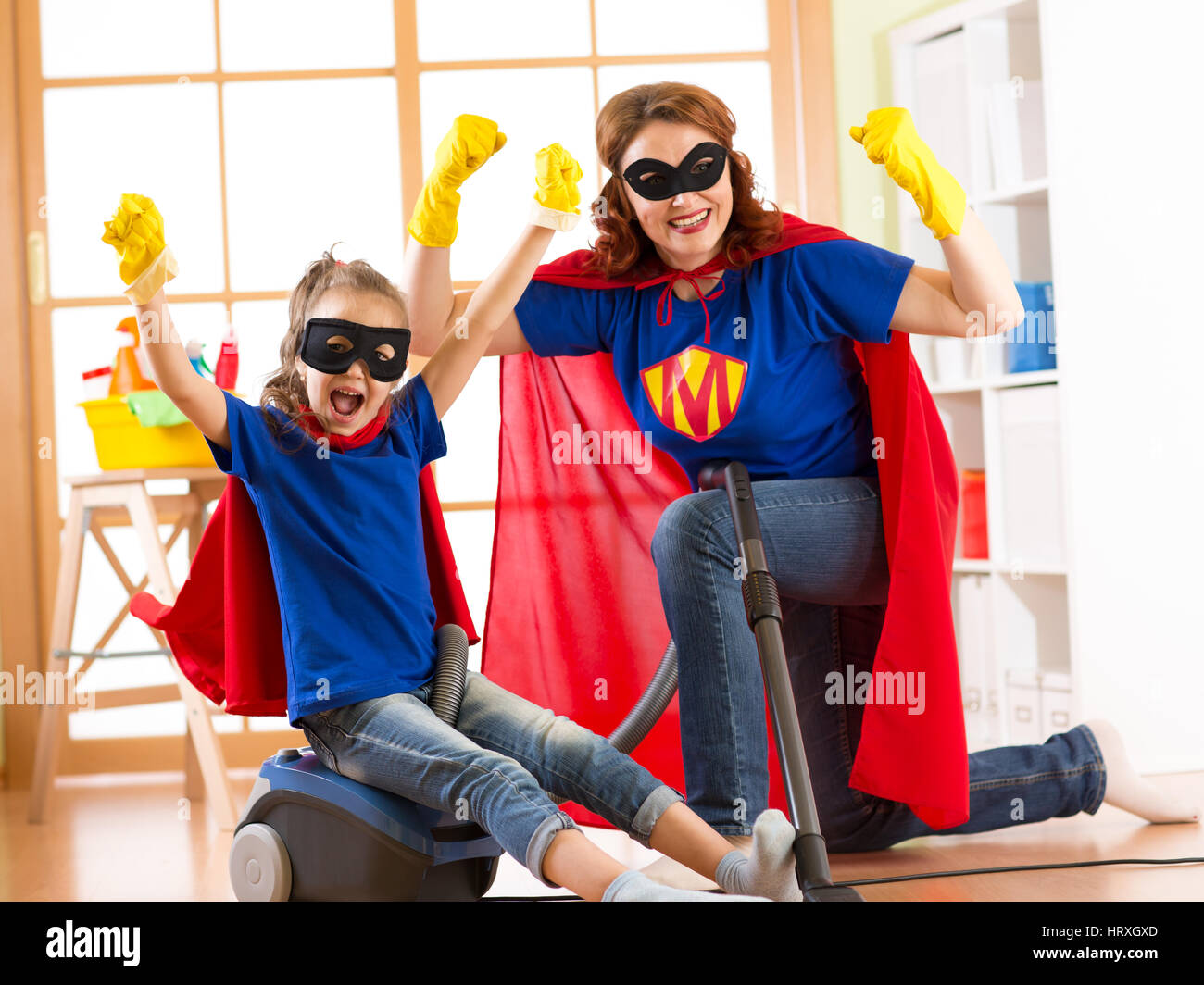 Strong superhero housewife and kid daughter ready to room cleaning ...