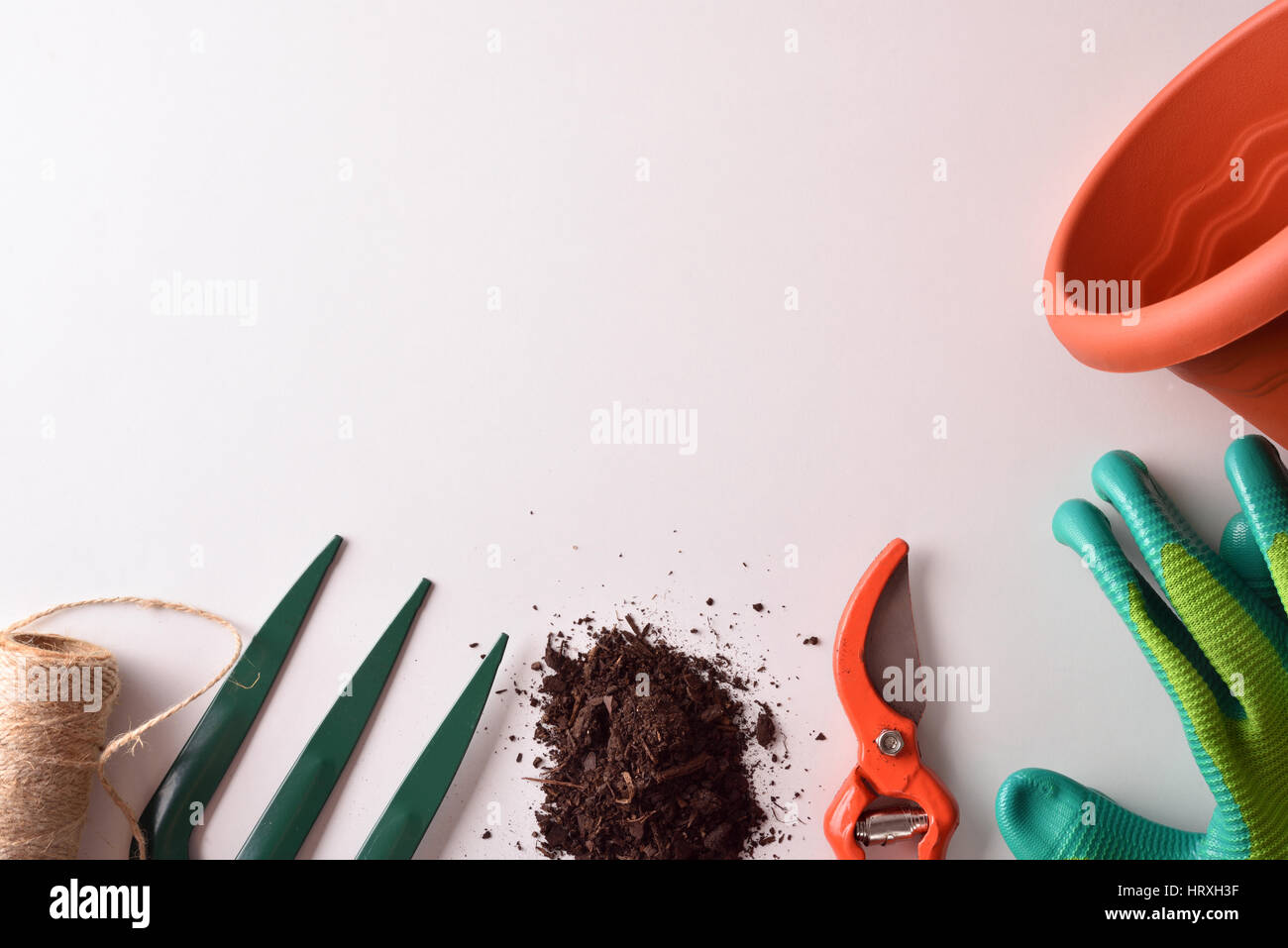 Gardening tools for trees, plants and flowers on white table. Top view ...