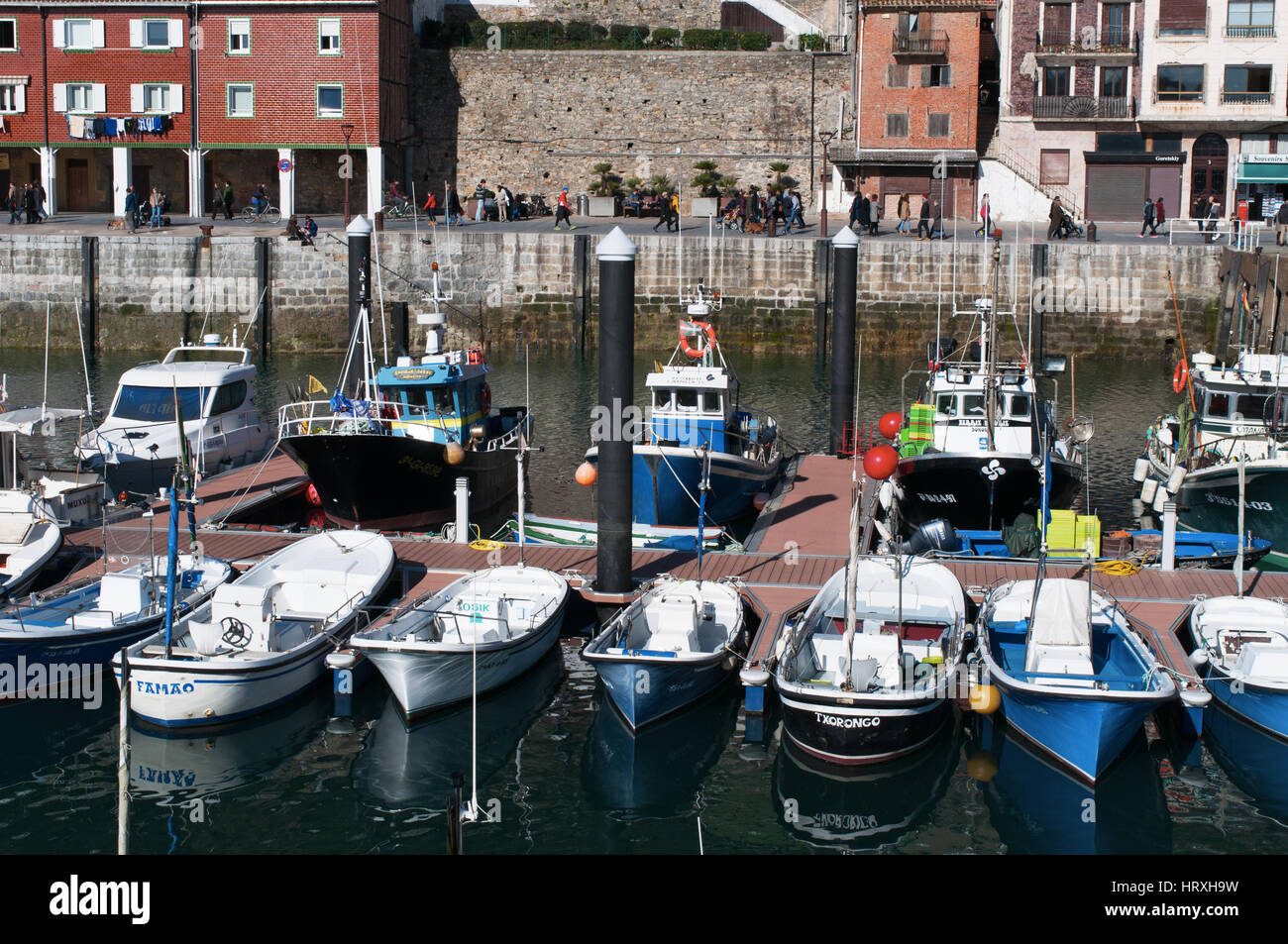 Spain: boats in the port and view of the skyline on the seafront of ...