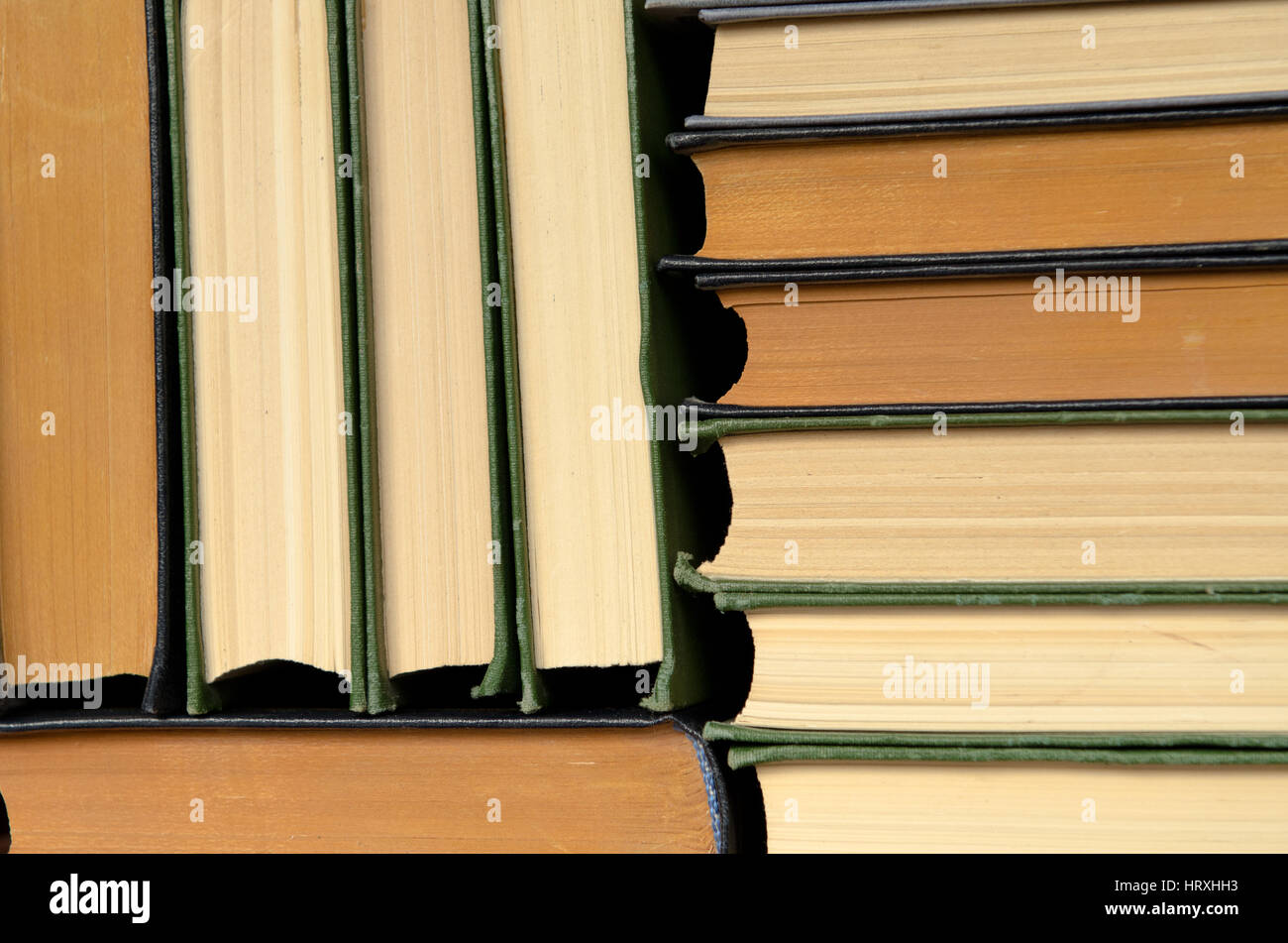 a stack of colorful books in a library or a room Stock Photo - Alamy