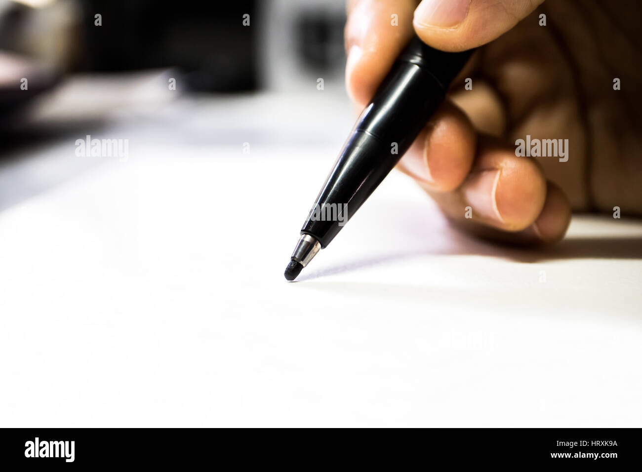 Hand holding pen closeup view Stock Photo - Alamy