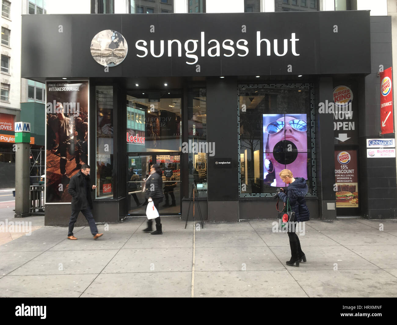 People walking passed mobile phone shop hi-res stock photography and ...