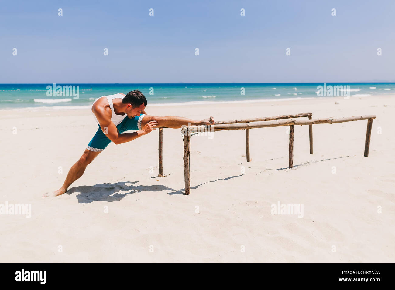 man stretching and doing gymnastic on the beach Stock Photo - Alamy