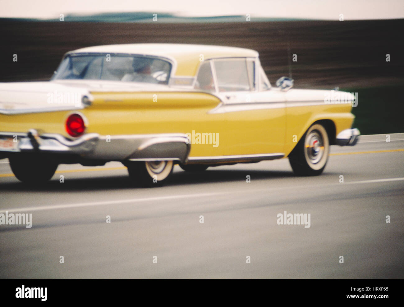 Old yellow car cruising down highway Alberta, Canada Stock Photo - Alamy