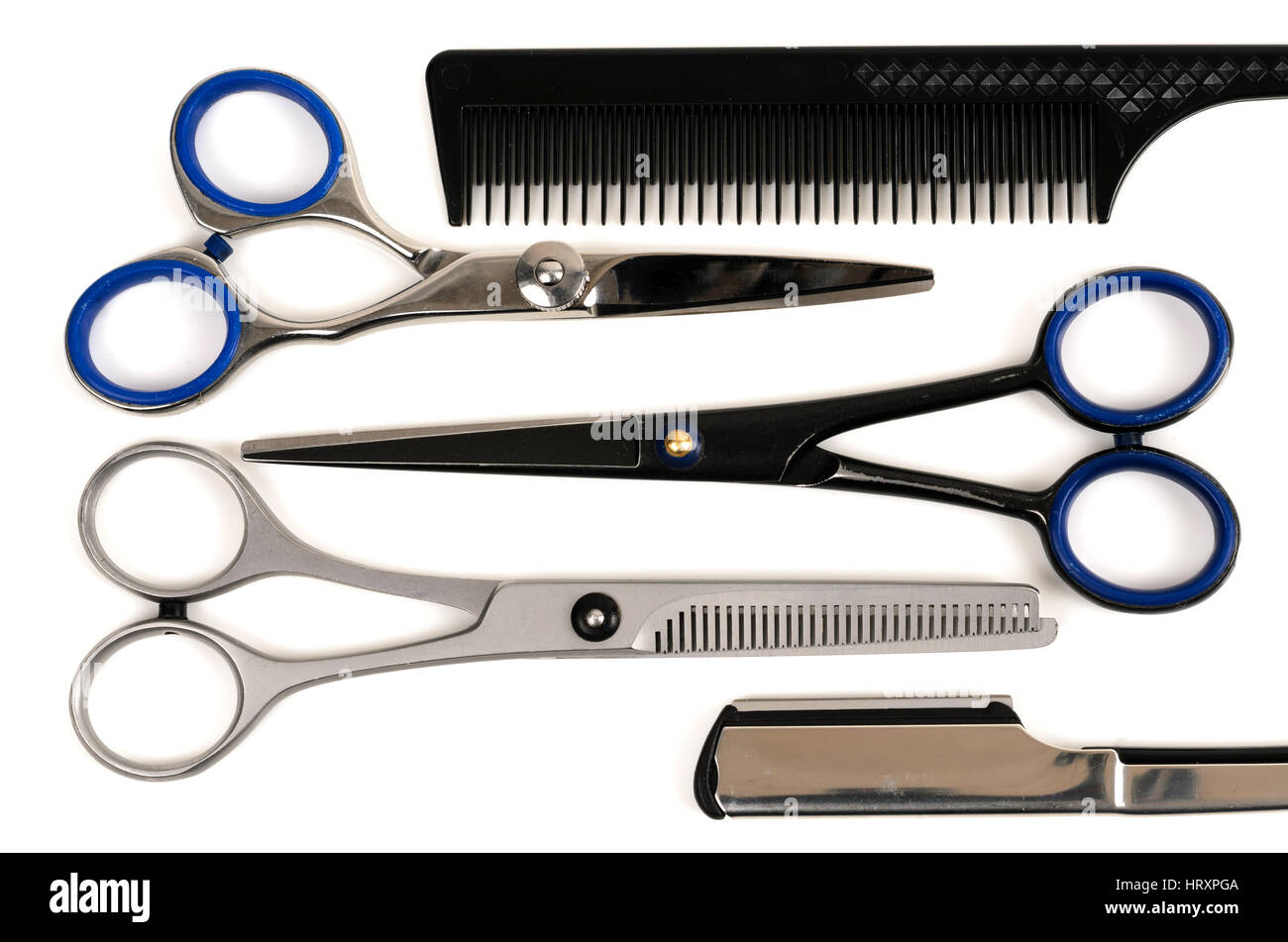 Professional haircutting scissors and comb isolated on white background ...