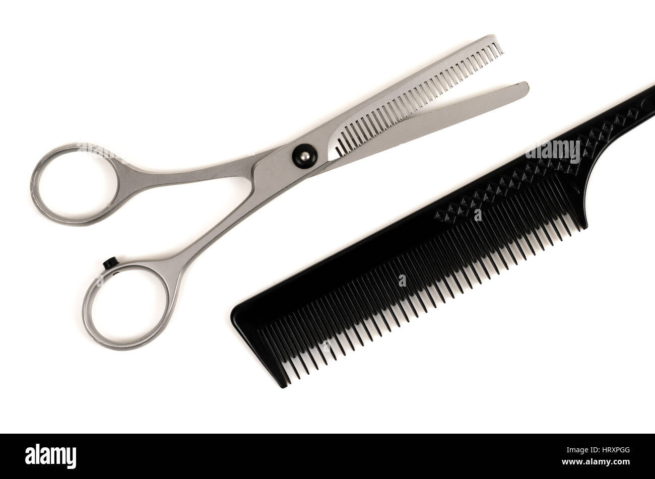 Professional haircutting scissors and comb isolated on white background ...