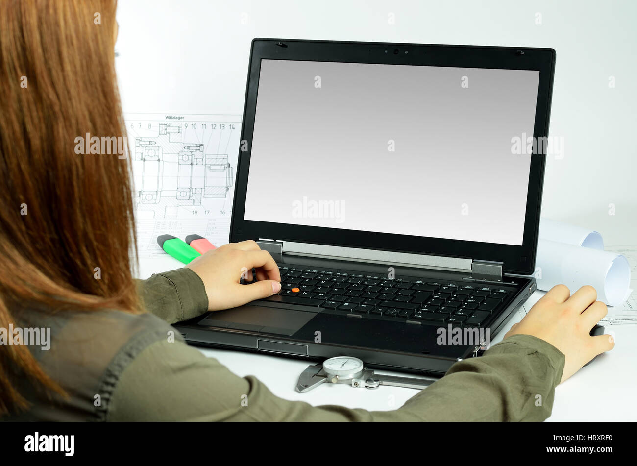 Young woman sitting in front of a laptop back view Stock Photo - Alamy