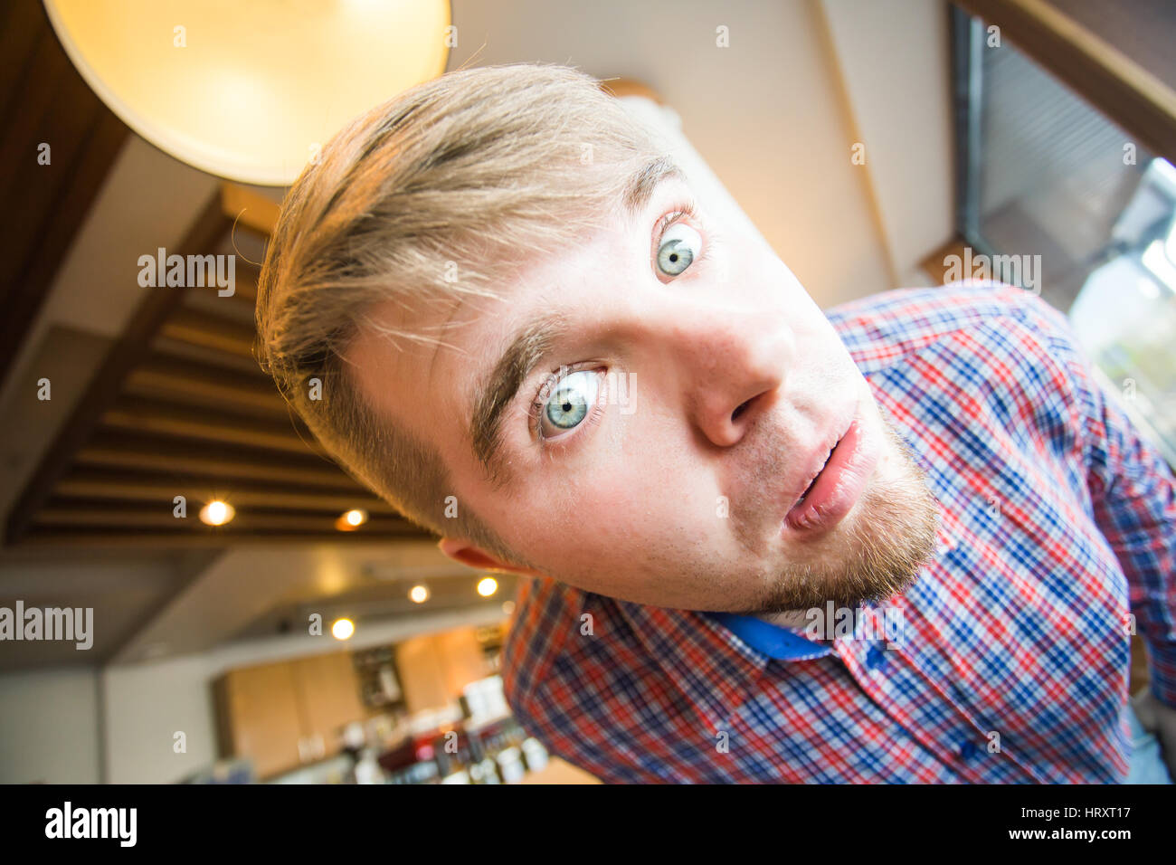 Funny guy making faces at camera celebrating fools day Stock Photo - Alamy
