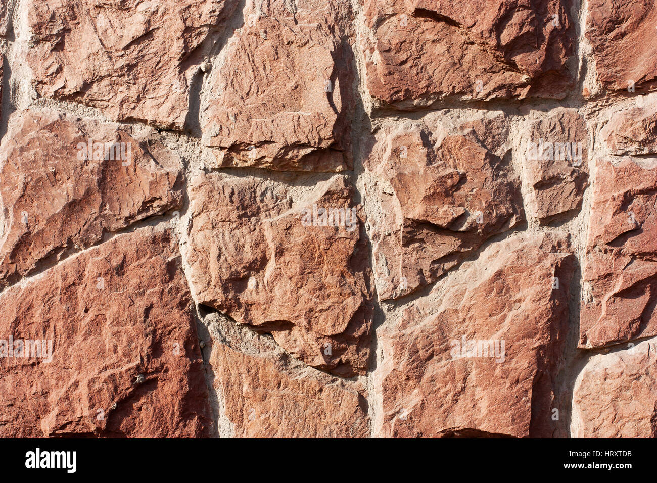 Textured wall background of red stone Stock Photo - Alamy