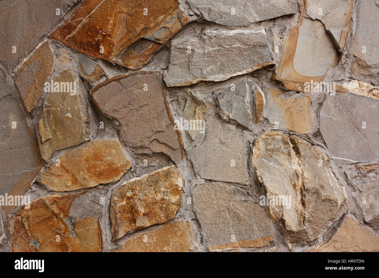Textured wall background of gray and yellow stone Stock Photo - Alamy