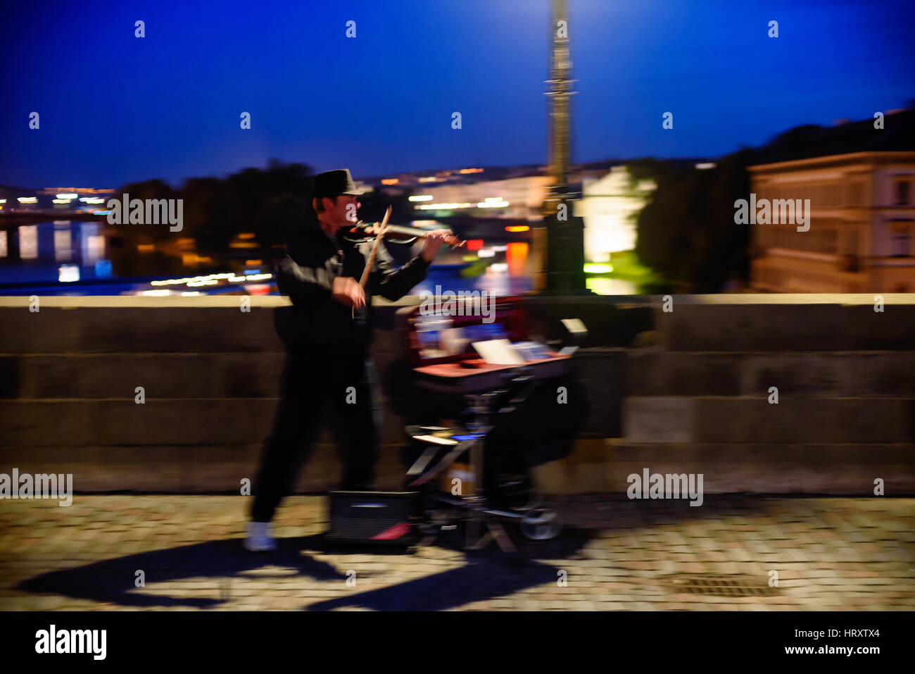 Movement of a violin busker performing along Charles Bridge in Prague ...
