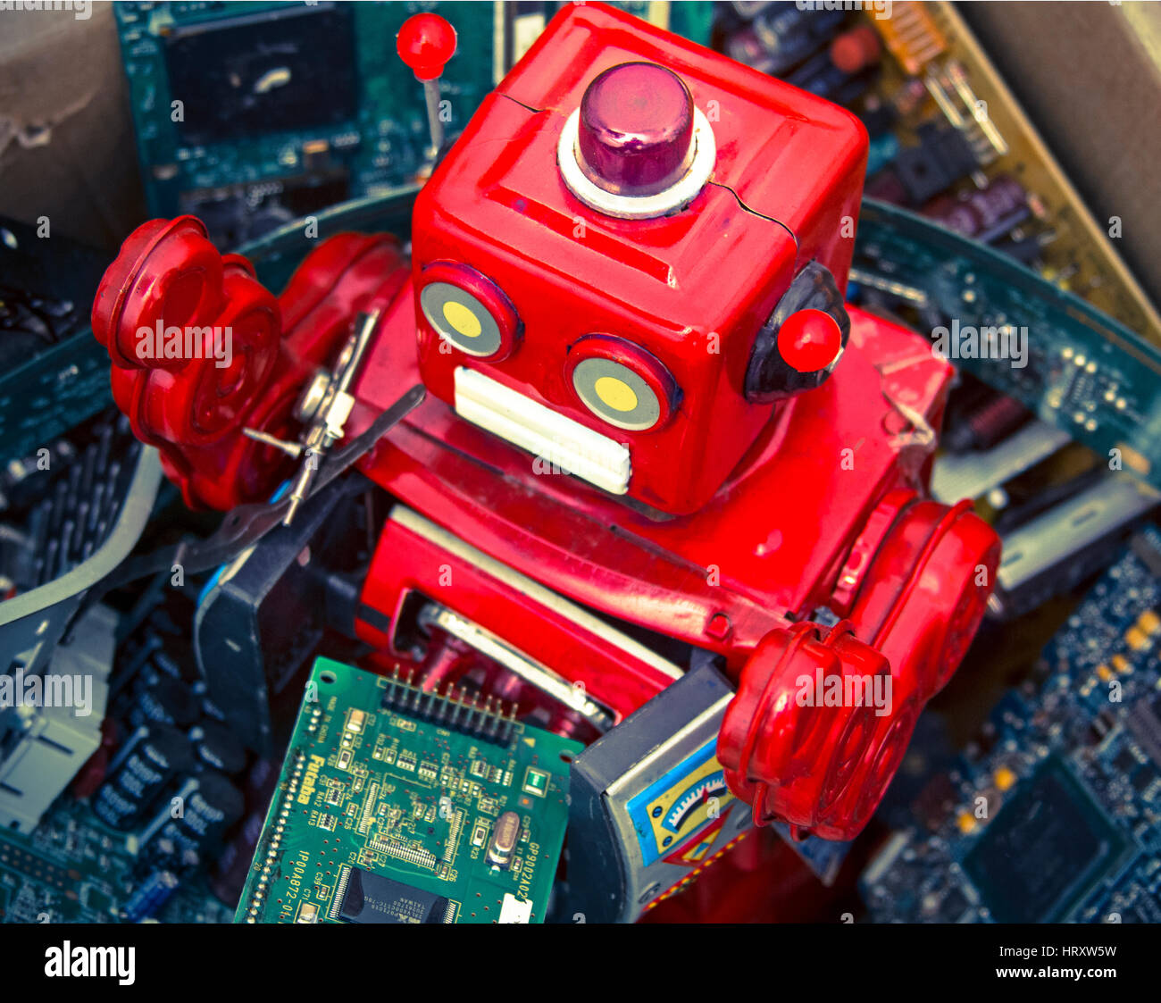 red robot buried in old electronics Stock Photo - Alamy