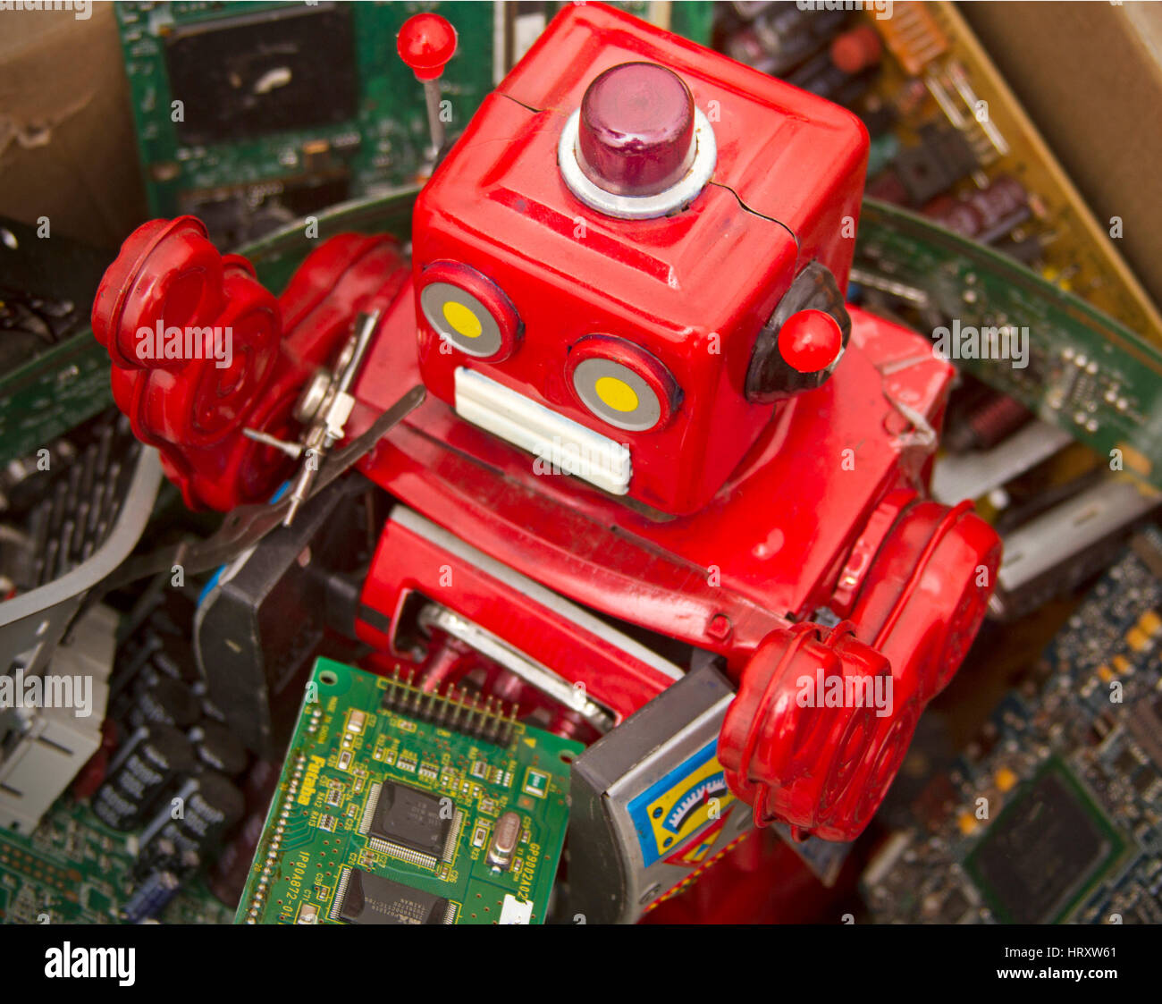 red robot buried in old electronics Stock Photo - Alamy