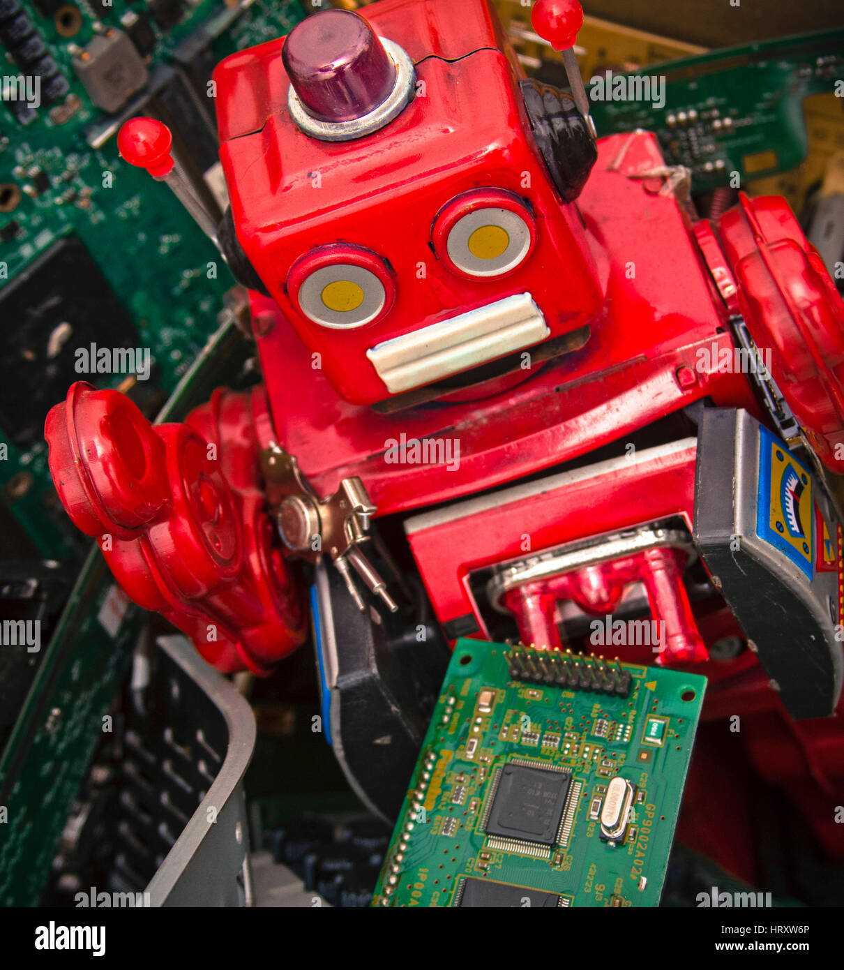 red robot buried in old electronics Stock Photo - Alamy