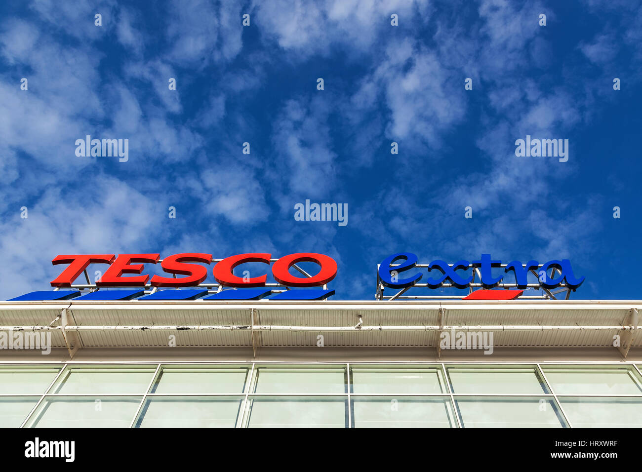 Bright Red Tesco Extra Store Sign Set Against Mottled Blue and White ...