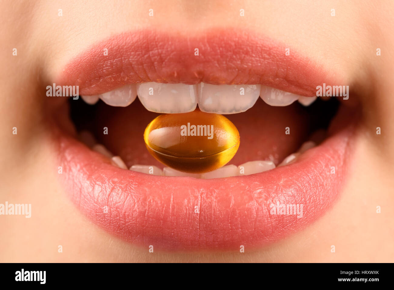 Young woman takes a pill Stock Photo - Alamy