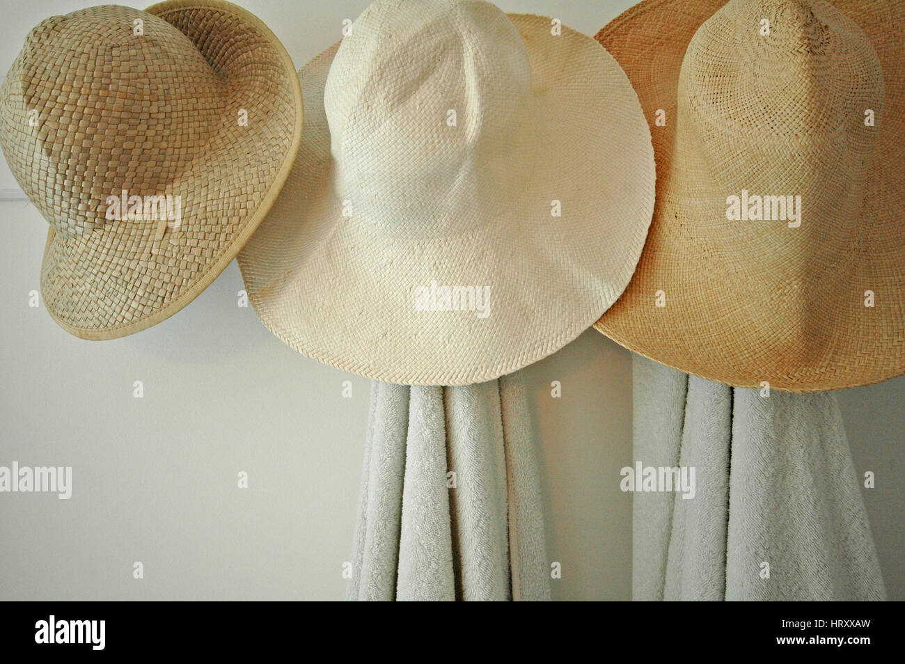 Hats hanging in a coastal holiday cottage Stock Photo - Alamy