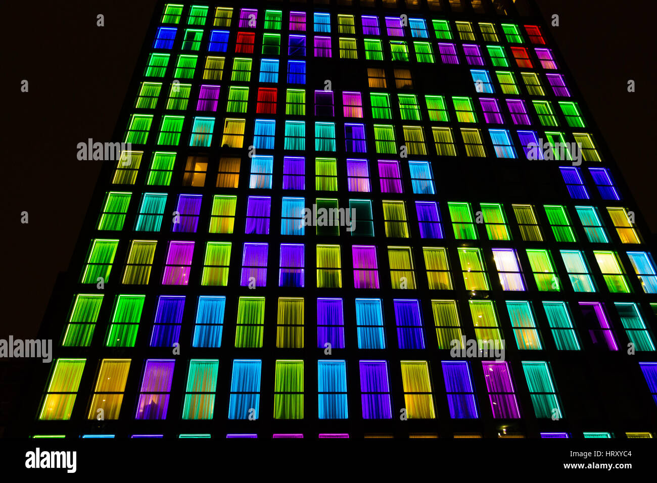 Colored windows texture. Windows illuminated by neon lights background ...