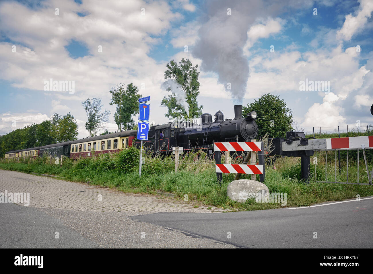 The excursion steam train at the crossing Stock Photo - Alamy