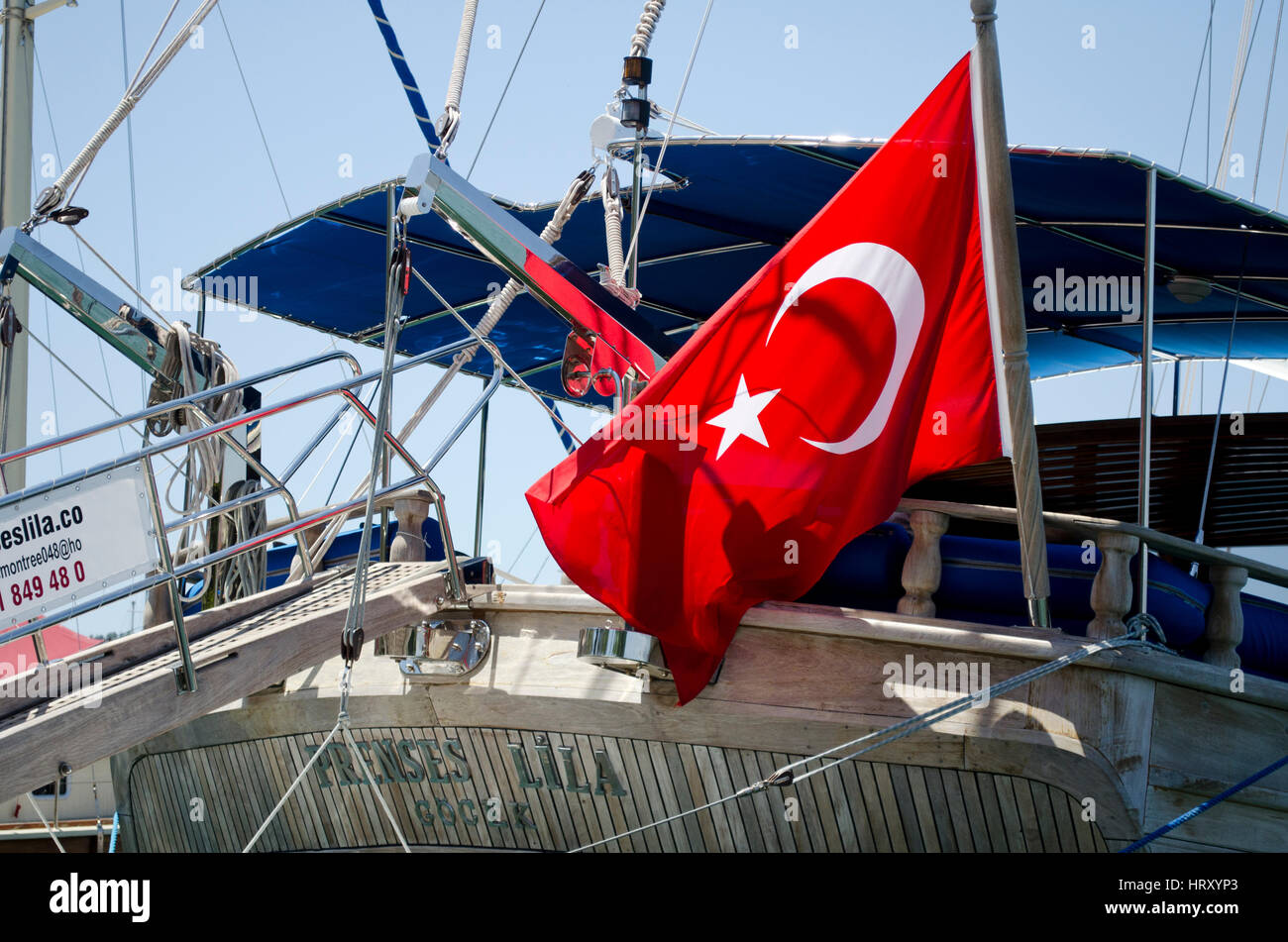 Turkish flag flying on rear of yacht in harbour with other turkish ...