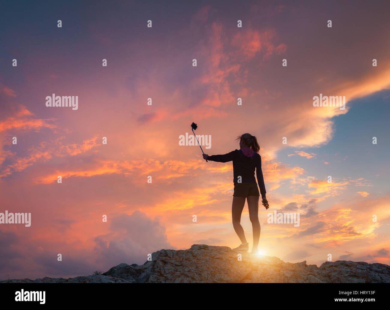 Beautiful young woman makes selfie for Instagram at sunset. Landscape ...
