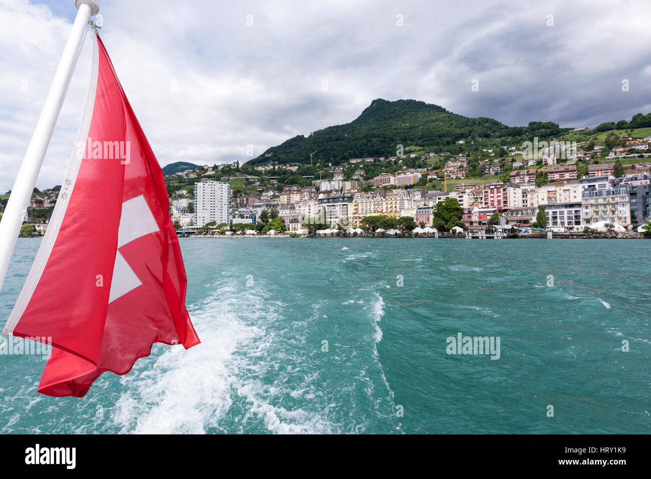 View of Montreux from the steam boat and the Swiss flag, Vaud ...