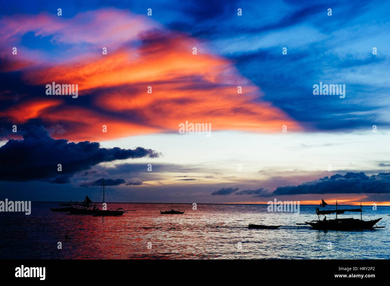 Beautiful, colorful sunset over fishing boats and people in water Stock ...