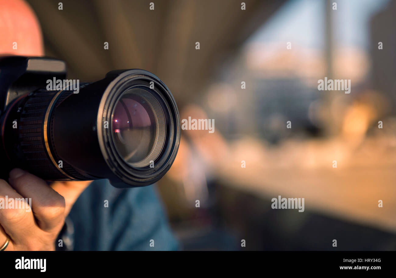 Photographer shooting with a DSLR camera. The camera is on the ...