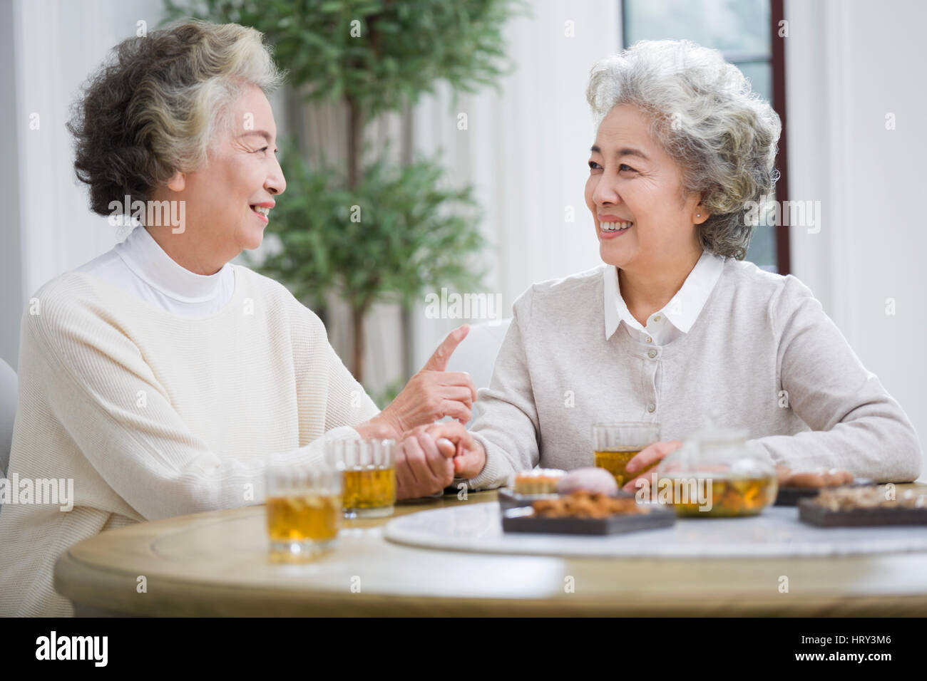 Happy senior women talking and drinking tea Stock Photo - Alamy