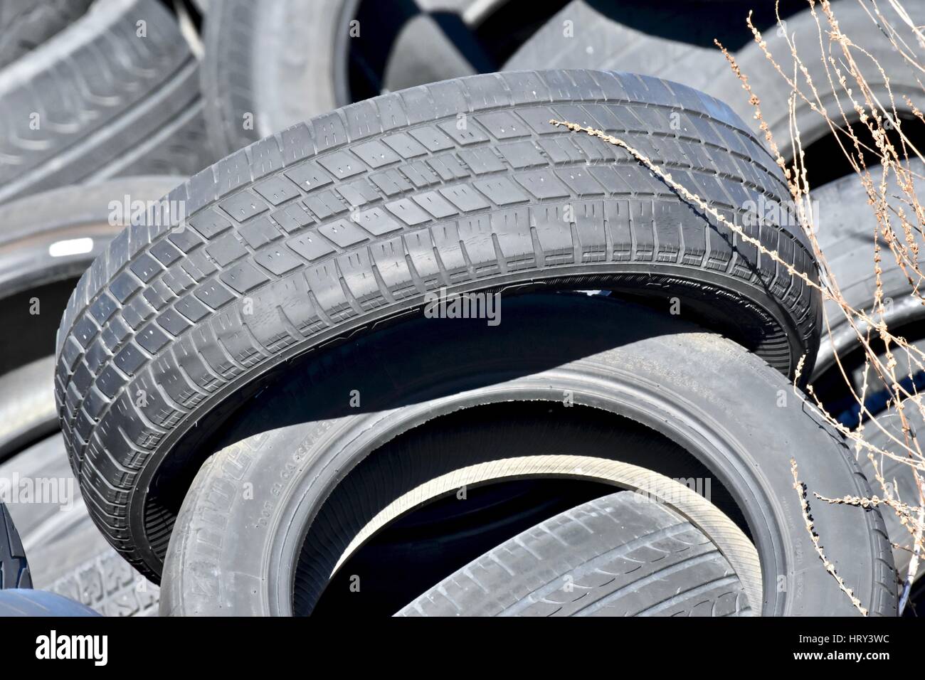 Pile of used tires in a junk yard Stock Photo - Alamy