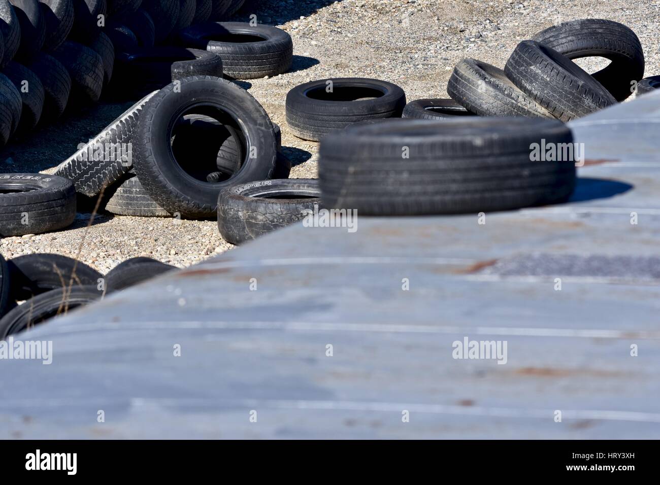 Pile of used tires in a junk yard Stock Photo - Alamy