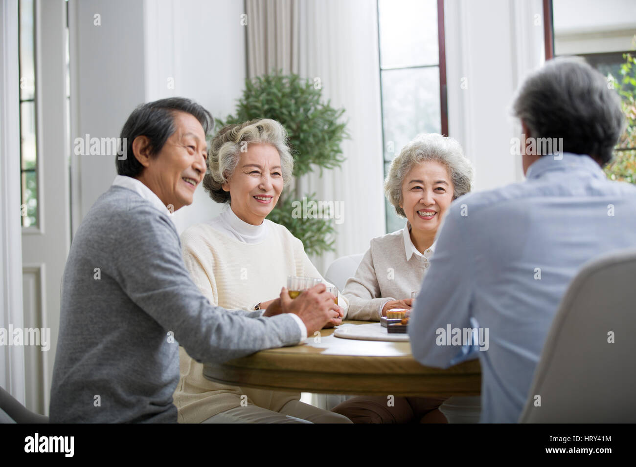Happy senior friends talking and drinking tea Stock Photo - Alamy