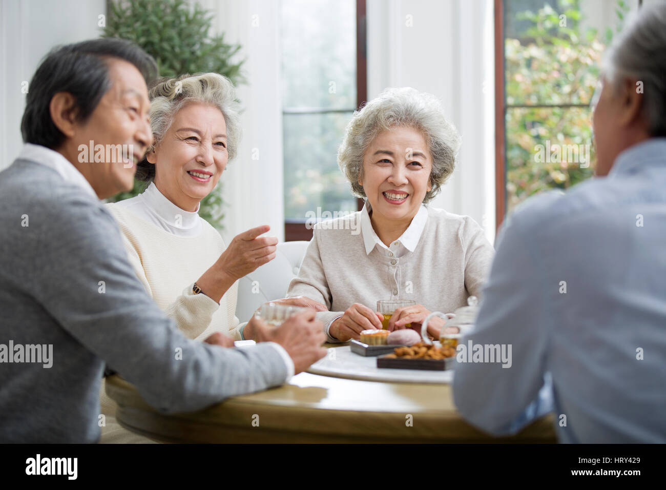 Happy senior friends talking and drinking tea Stock Photo - Alamy