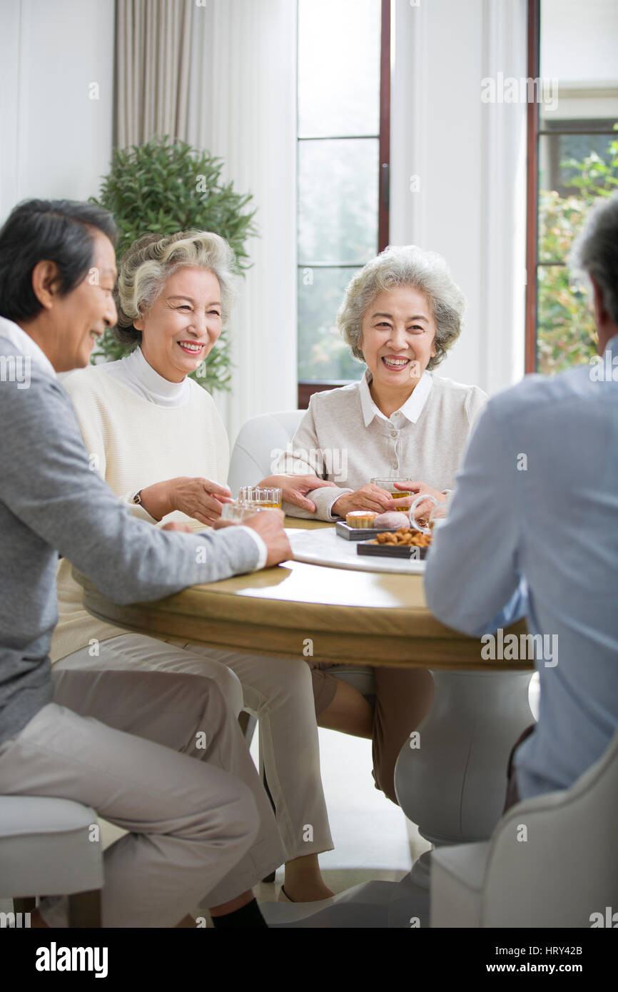 Happy senior friends talking and drinking tea Stock Photo - Alamy