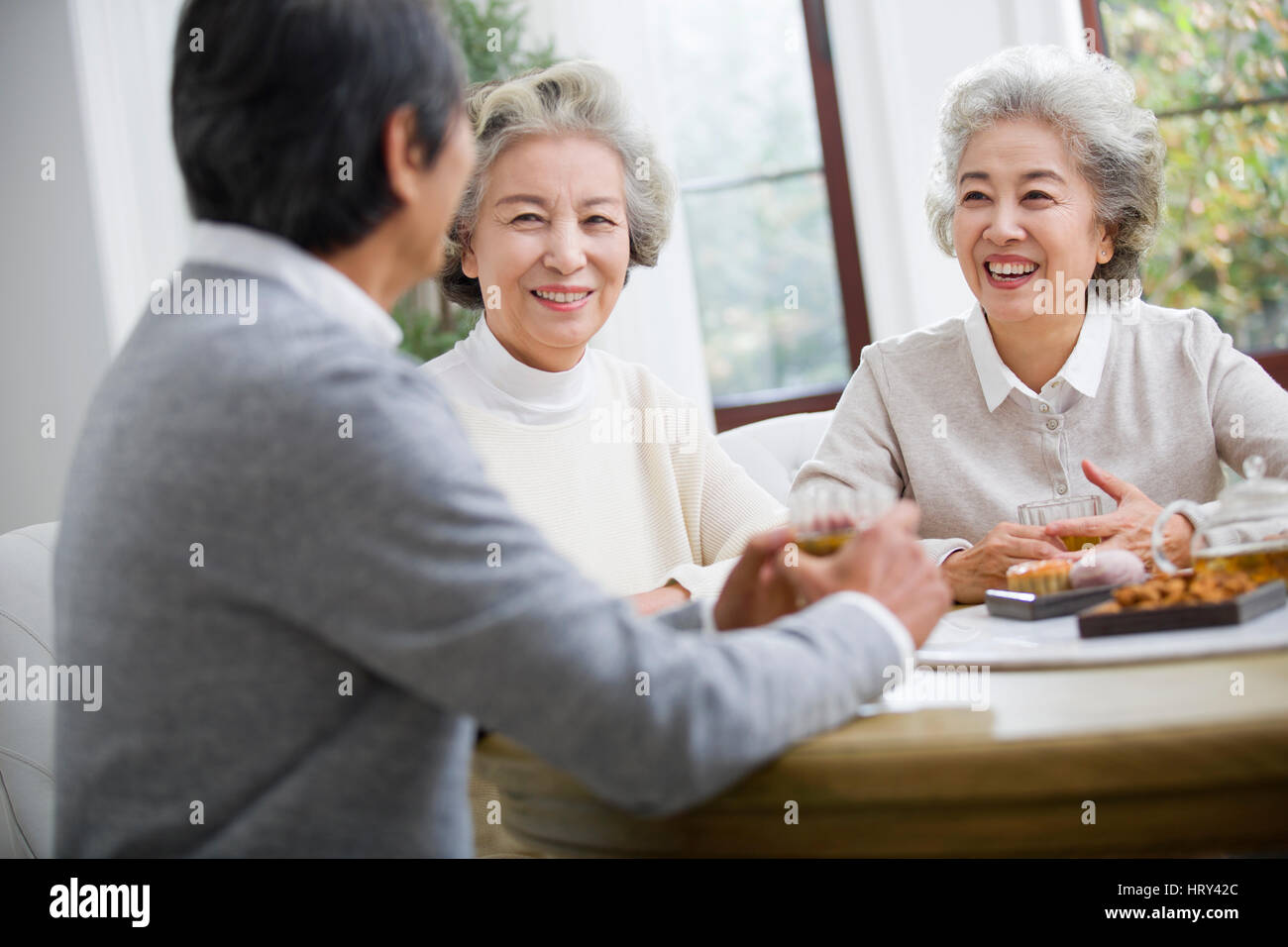 Happy senior friends talking and drinking tea Stock Photo - Alamy