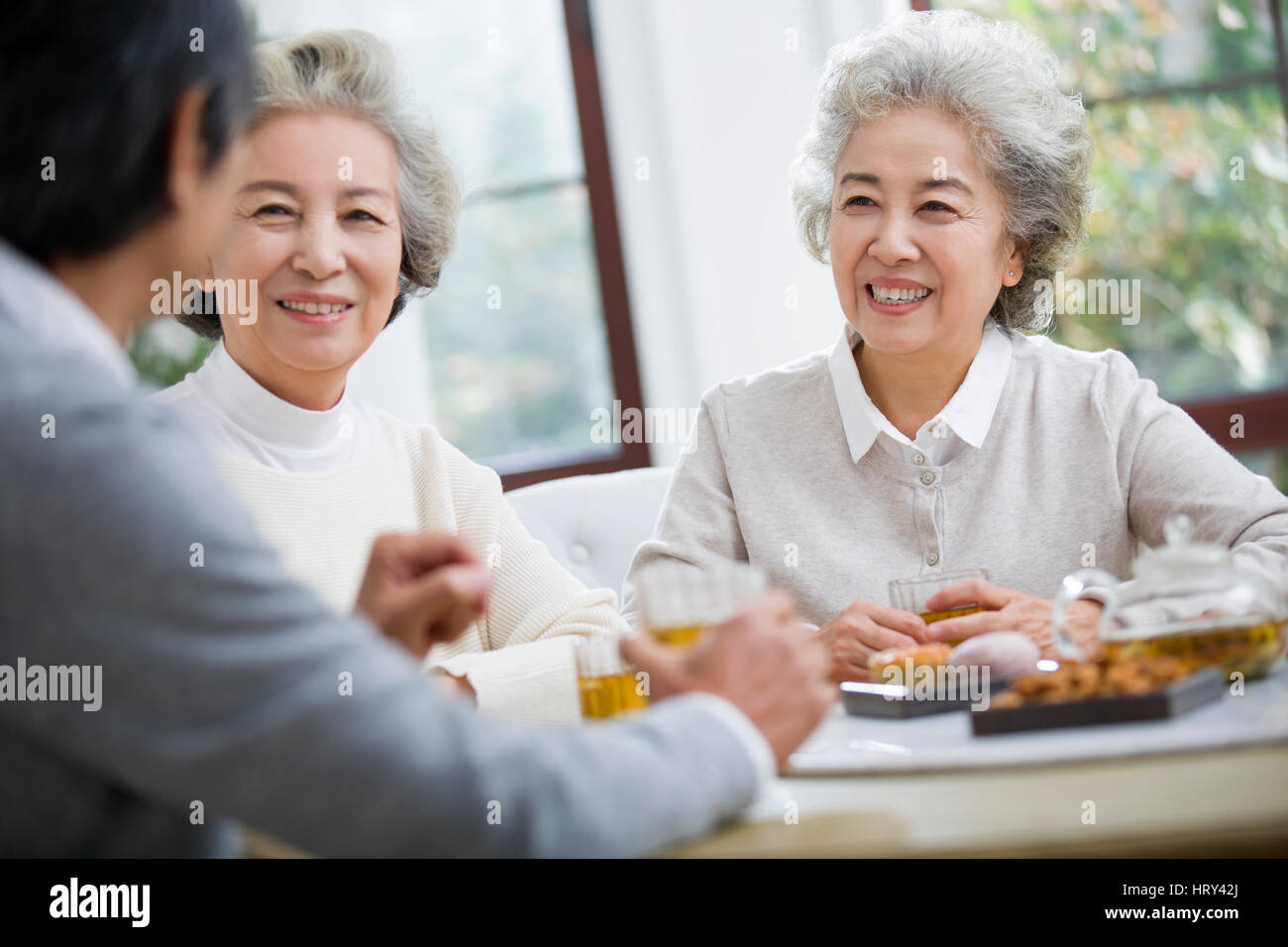 Happy senior friends talking and drinking tea Stock Photo - Alamy